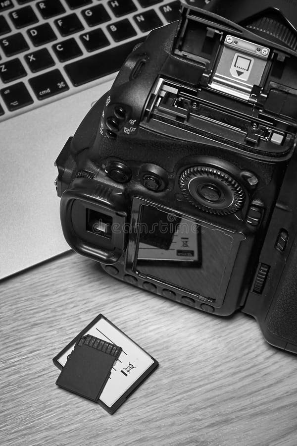 DSLR Camera and Memory Cards on a Table Next To the Computer, Top View ...