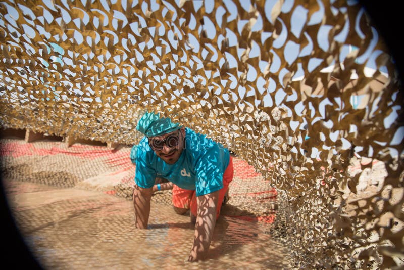 Dubai, UAE - Feb 10, 2017: Participant Competing on an Obstacle Course ...