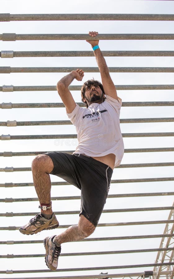 Dubai, UAE - Feb 10, 2017: Participant Competing on an Obstacle Course ...