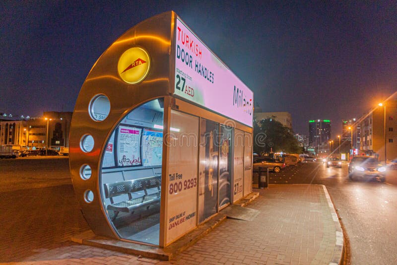 An Air Conditioned Bus Stop in Dubai with a Tourist Reflection in the ...