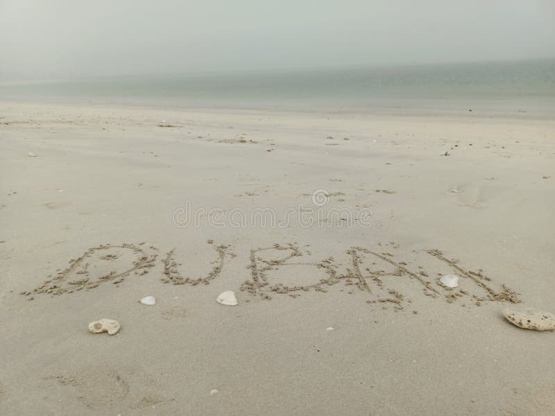 Dubai Written in Beach Sand Stock Image - Image of wind, white: 253643635