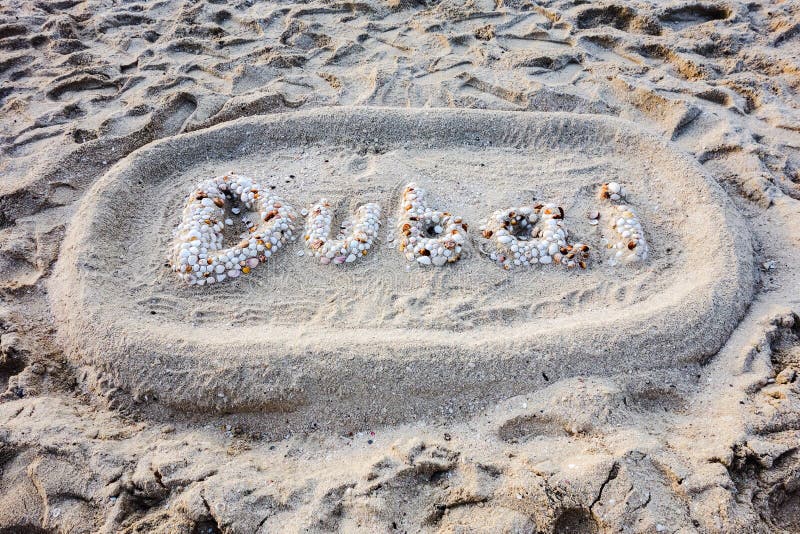 Dubai, Written with Shells in Desert Sand Stock Image - Image of sand ...