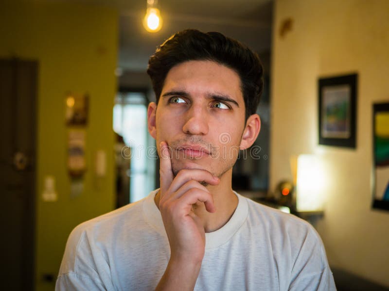 Dubious, Unsure Handsome Young Man Thinking, at Home Stock Photo ...
