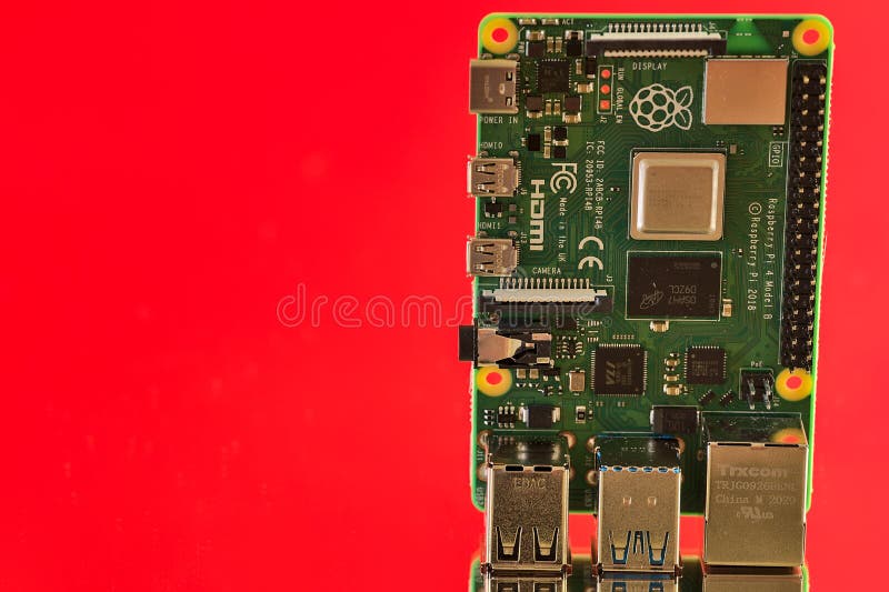 Beautiful Closeup View Of Raspberry Pi 4 Model B Minicomputer On Reflective Red Surface
