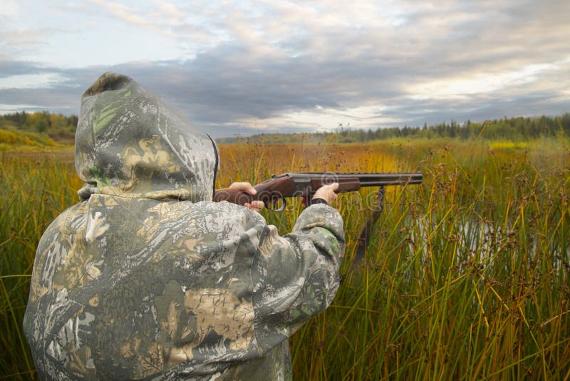 Duck Hunting in Autumn. a Man with a Gun is Hunting Ducks Stock Photo ...