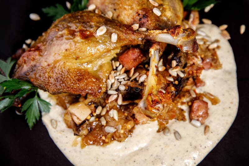 Duck Leg with White Sauce on a Dark Plate Stock Photo - Image of french ...