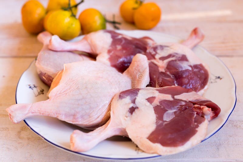 Duck Meat Fresh, Raw Duck Legs with Fruit on a Wooden Surface. Stock ...