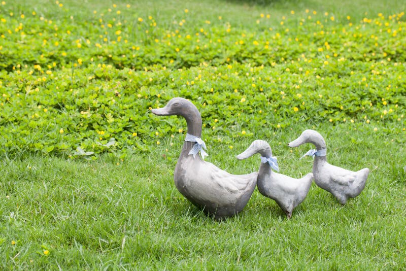 Duck Statues in Green Grass Stock Photo - Image of pond, statue: 45635480