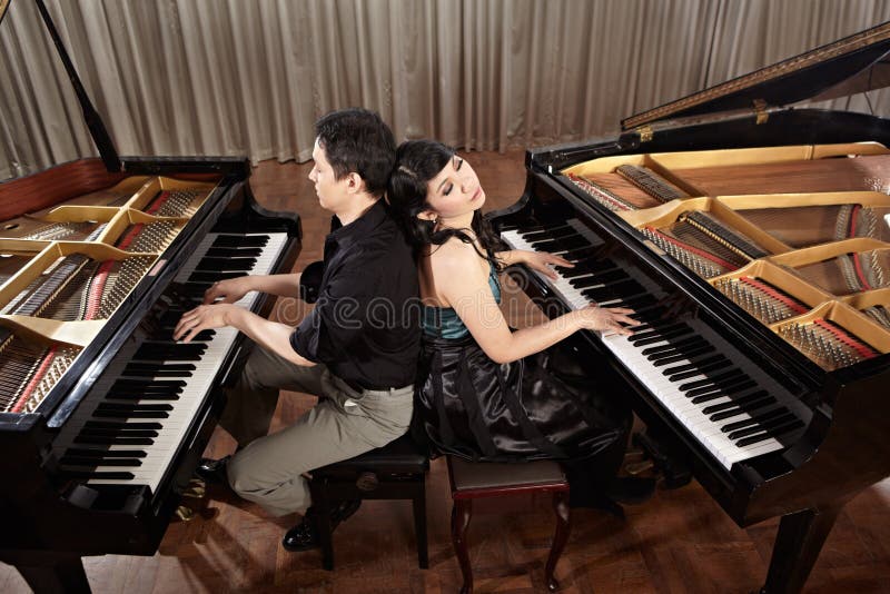 Piano duet stock image. Image of artist, male, female - 30626079