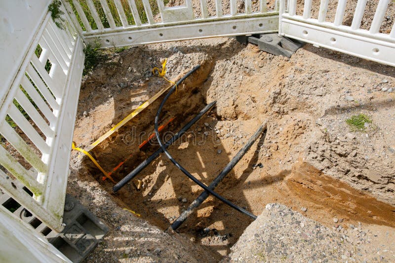 Dugged Hole for Electricity with Wires on a Construction Site. Building ...