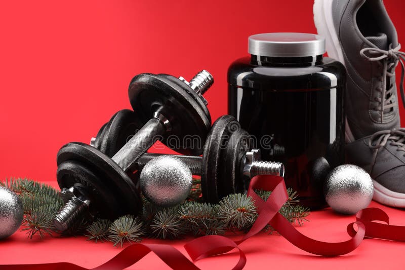 Dumbbells, Container with Supplement, Sneakers and Christmas Decor on ...