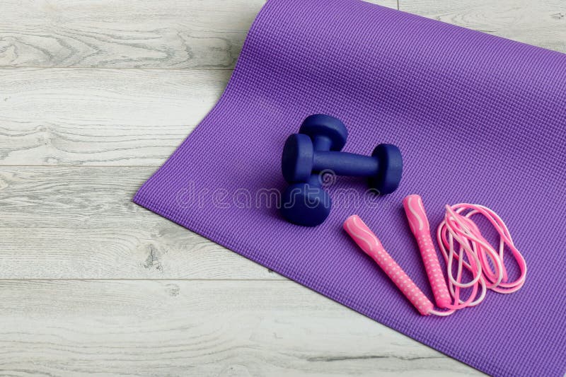 Dumbbells with a Jump Rope on a Gym Mat Stock Photo - Image of practice ...