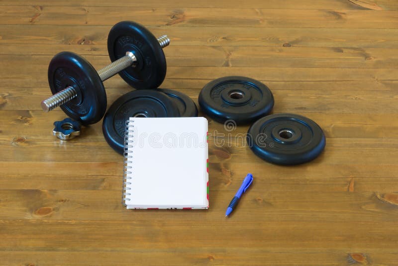 Dumbbells with a Notebook To Record Results Stock Photo - Image of ...