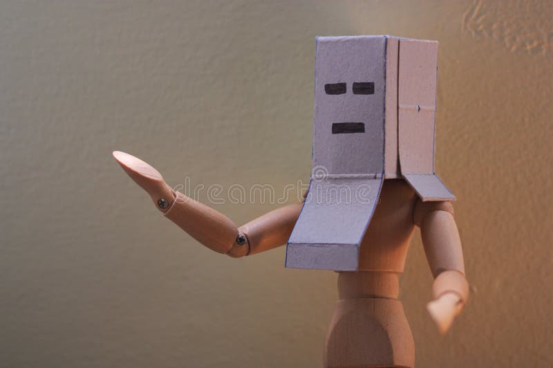 A Dummy with a Face Painted on a Box Raises His Right Arm Stock Photo ...