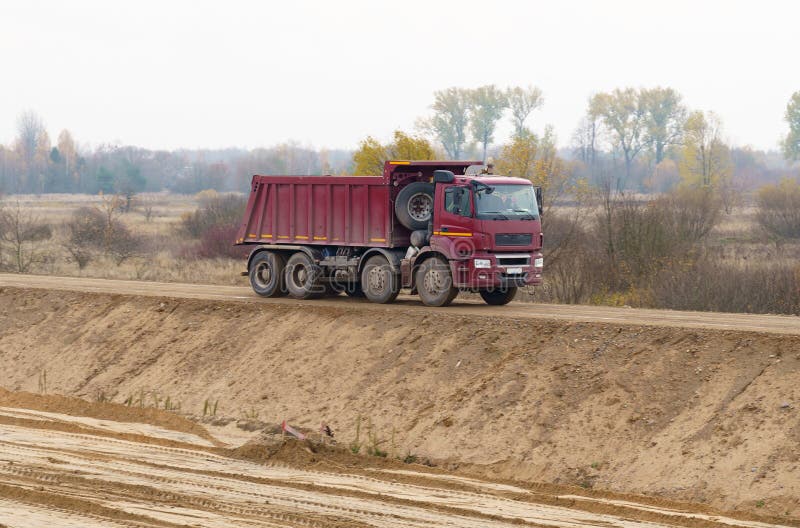The Dump Truck Delivers Sand on a Dirt Road Stock Photo - Image of soil ...