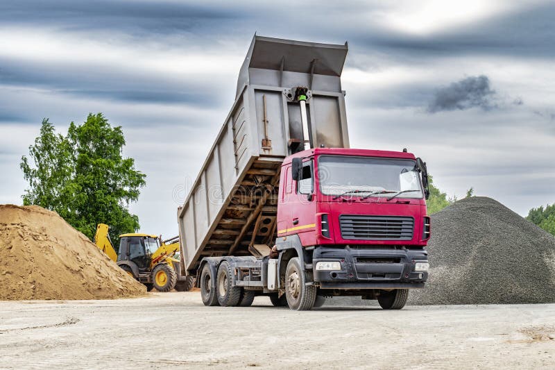 Dump Truck with a Raised Body at a Construction Site. Transportation ...