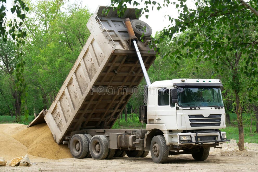 A Dump Truck Unloads Sand among the Trees - in a Forest or Park ...