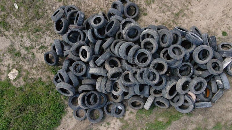 Dump of Unwanted Tires Lying on the Ground in an Open Field Stock ...