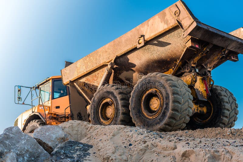 Dumper Transporting Large Rocks To Reinforce a Stock Image - Image of ...