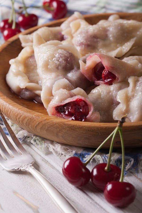 Dumplings with Cherry Close-up in a Wooden Bowl. Vertical Stock Photo ...