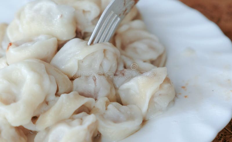 Dumplings on a Plate on Wooden Table. Closeup View. Stock Photo - Image ...
