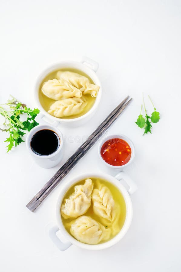 Dumplings are Served in White Cups with Sauces on a Serving Board . Top ...