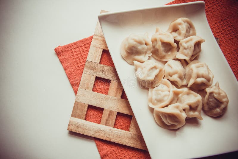 Dumplings on square plate stock photo. Image of dinner - 64675360