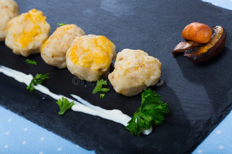 Dumplings of Tasty White Fish Served with Greens at Plate on Table ...