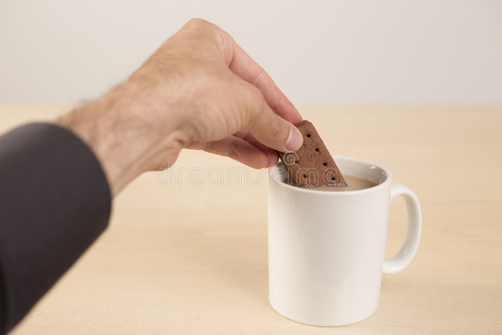 Dunking a Chocolate Biscuit into Tea Stock Photo - Image of food ...