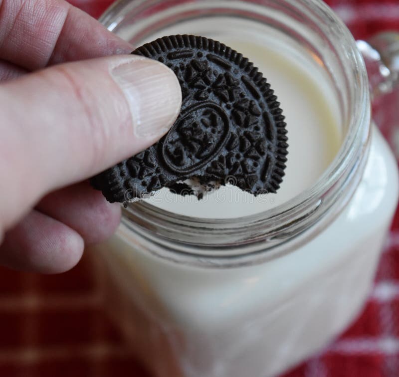 Dunking a Cookie in a Glass of Milk Stock Image - Image of holding ...