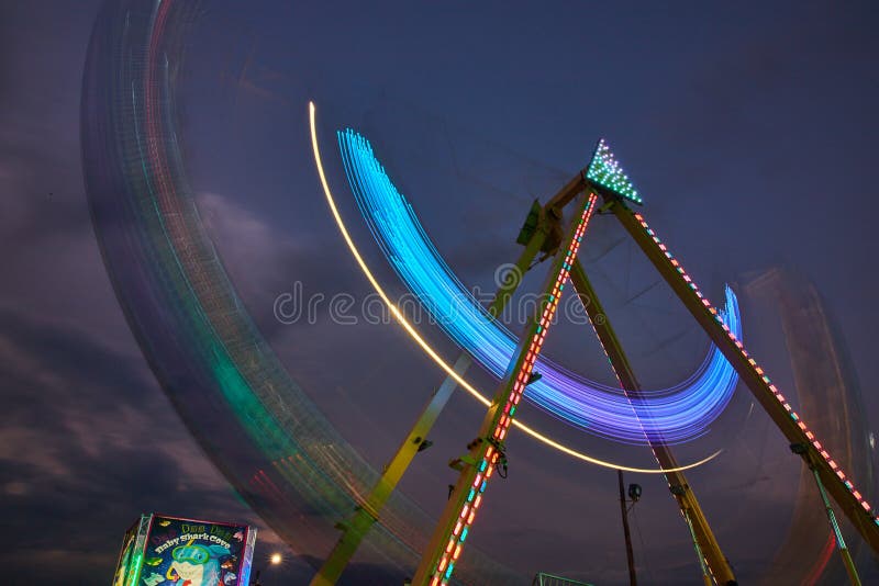 Dusk Carnival Ride Swinging with Blurred Lights at County Fair Stock ...