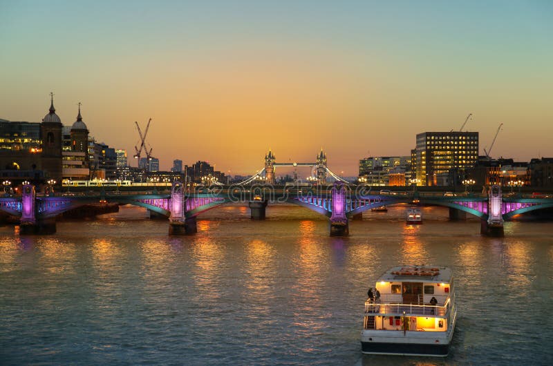 Dusk Over the Thames River with the Illuminated Tower Bridge in the ...