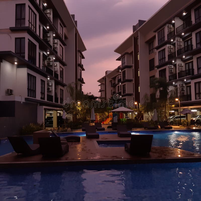 Dusk at the Pool stock photo. Image of aparrment, sunset - 205414078