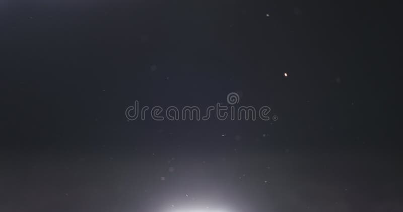 Dust Particles Fast Moving Over Black Background from Below Stock Photo ...