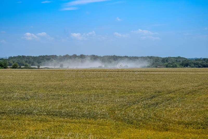Dust from Plowing Soil with Plough. Field of Rice. Rural Landscape ...
