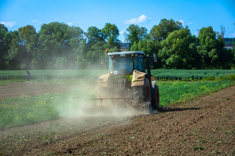 Dust Rising Up As Tractor Grinds Field Stock Photo - Image of season ...