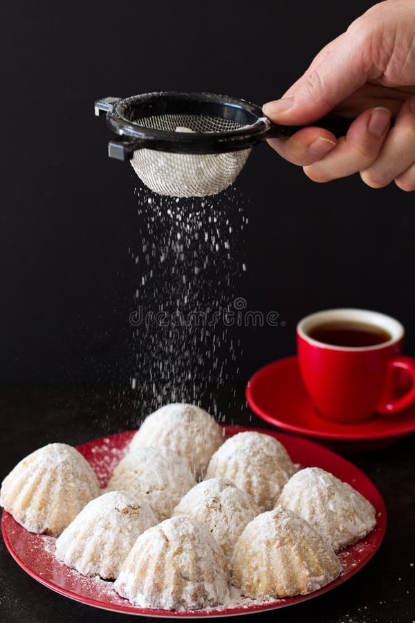 Dusting Eid Cookies with Icing Sugar Stock Photo - Image of table ...