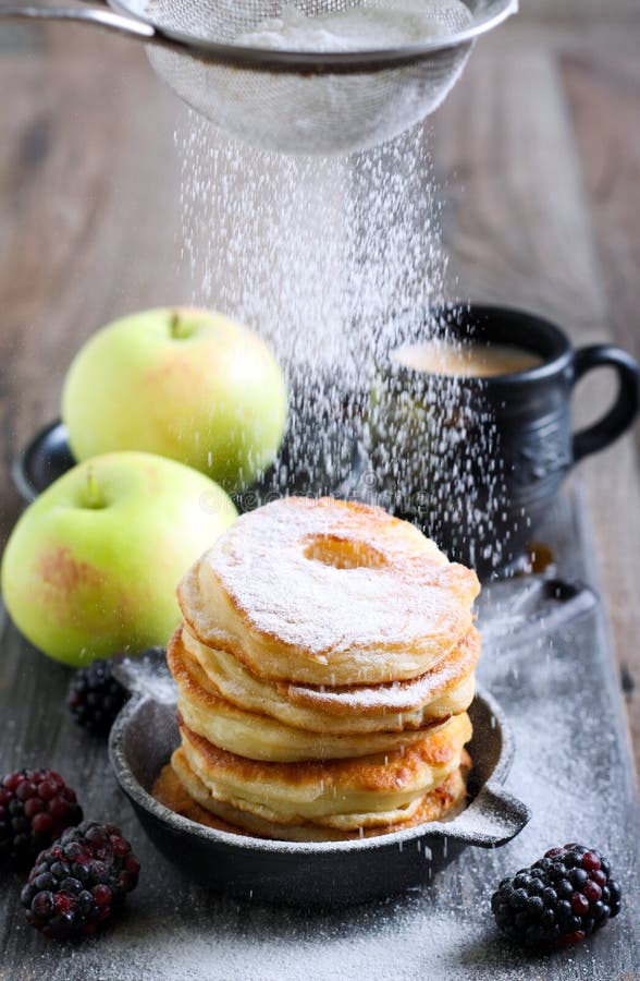 Dusting with Icing Sugar Over Apple Fritters Stock Photo - Image of ...