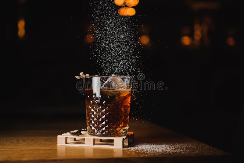 Dusting Whiskey Drink with Ice on Wood in Bar Stock Image - Image of ...