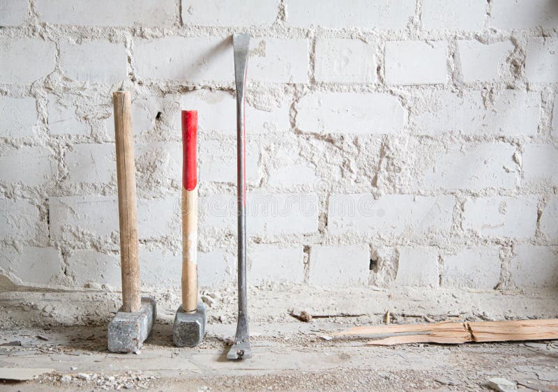 Dusty Construction Tools Near White Brick Wall Stock Photo - Image of ...
