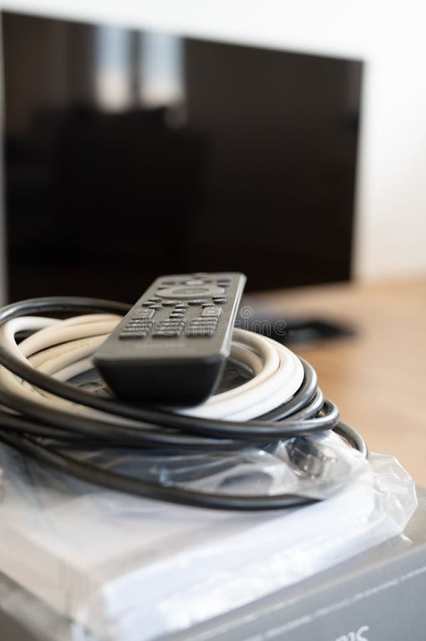 A Dusty Remote Control Placed on Same Cables when Unpacking a New TV ...