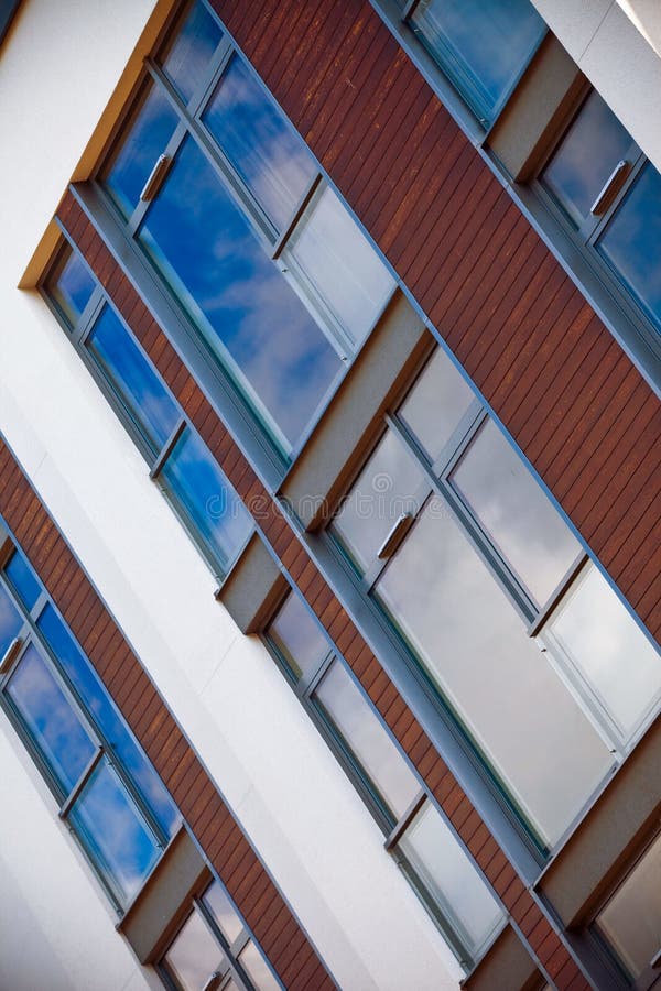 Dutch Angle Shot of the Clouds in the Sky Reflected on the Windows of a ...