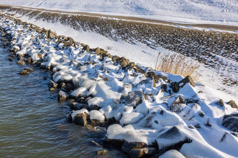 Dutch Breakwater with Basalt Stones Covered with Ice in Wintertime ...