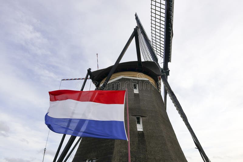 Dutch Flag in Front of a Traditional Windmill in Zevenhuizen Editorial ...