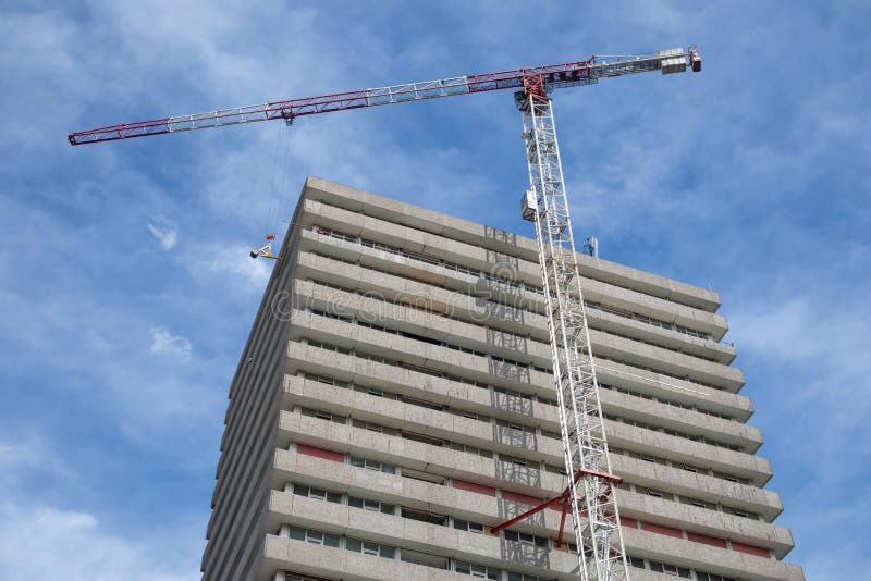 Crane Attached To Side of Building at Downtown Construction Site Stock ...