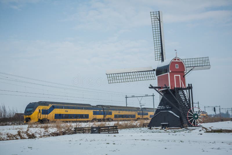 Dutch Train and Windmill in Winter Landscape Editorial Stock Image ...