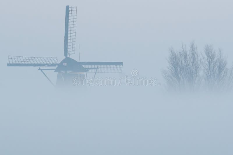 Dutch Windmill in the Ground Fog at Kinderdijk Stock Photo - Image of ...