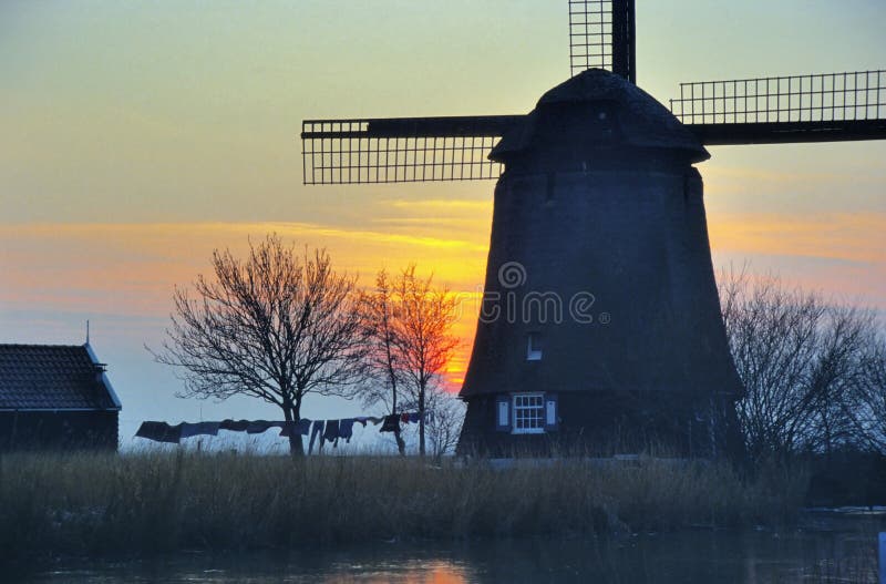 Dutch windmill at sunset stock image. Image of zenlike - 321355311
