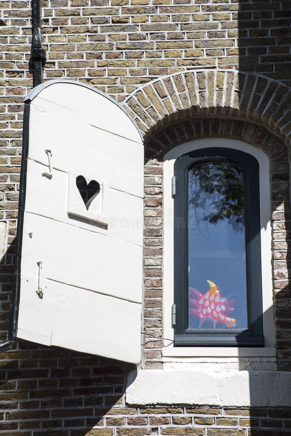 Shutters On Dutch Windows With Traditional Red And White Design Stock ...