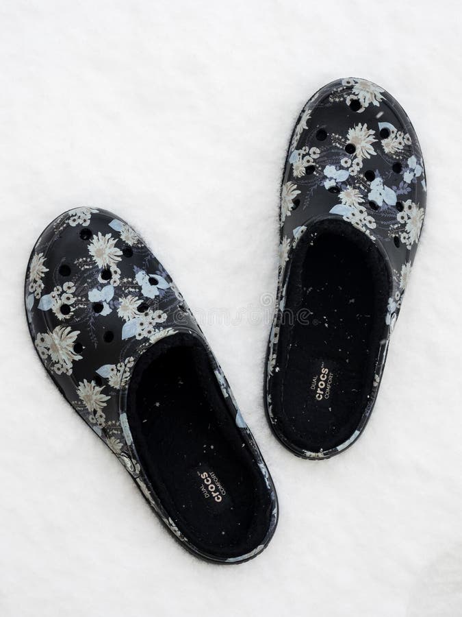 Pair of Lined Printed Crocs on Snow Editorial Image - Image of ...